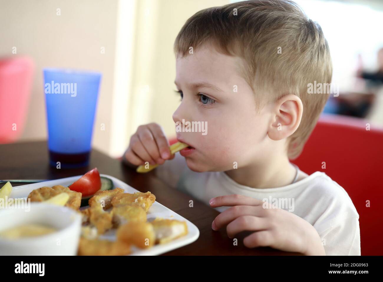 Child has french fries in a cafe Stock Photo - Alamy