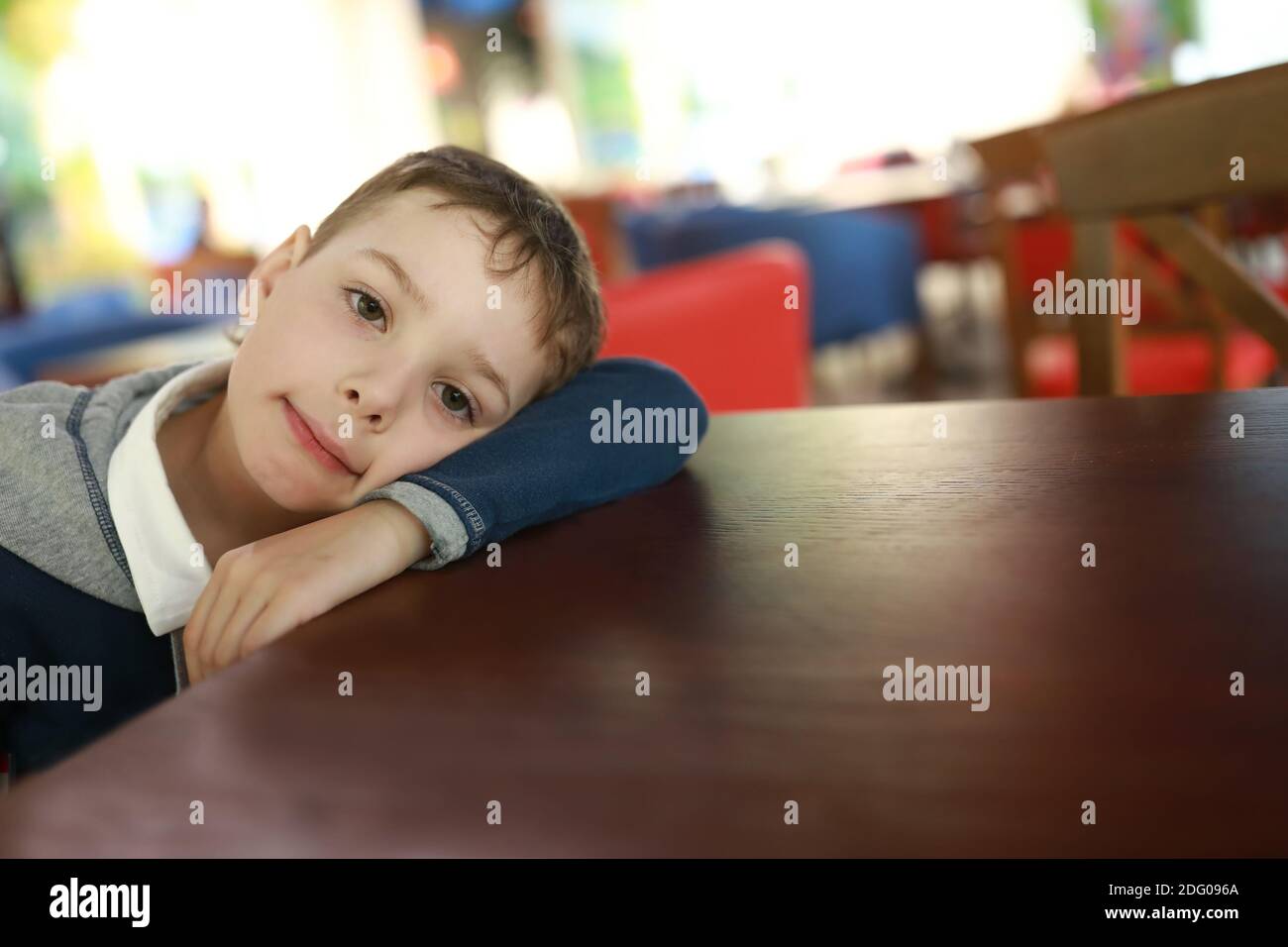 Portrait of a pensive boy in cafe Stock Photo - Alamy