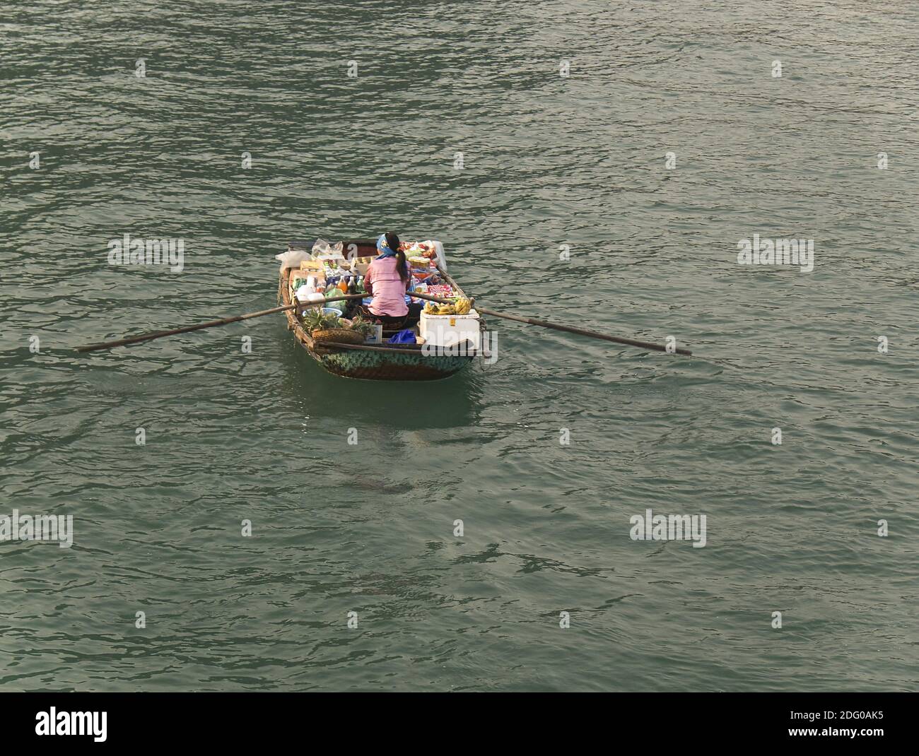 Trader in a rowing boat Stock Photo - Alamy