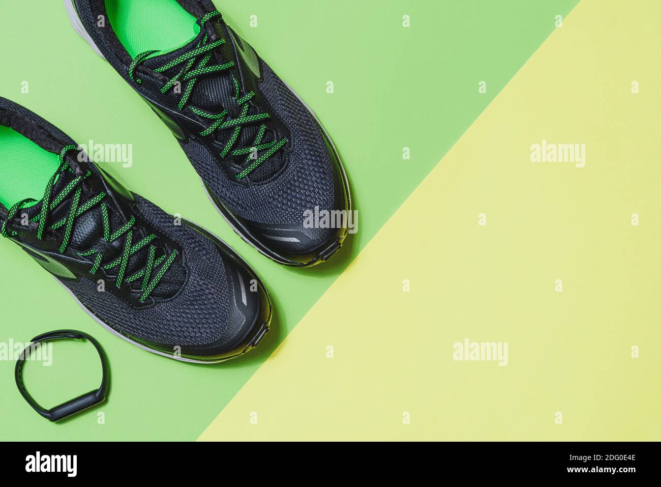 horizontal top view of a pair of black and green sport shoes and black ...