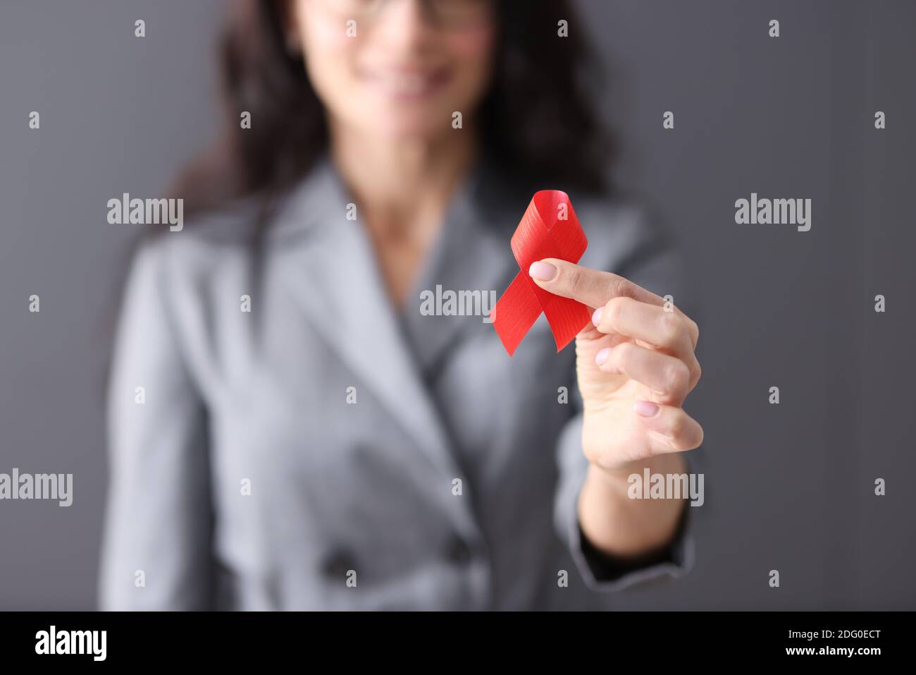 Woman in business suit holding red ribbon in her hands closeup Stock ...
