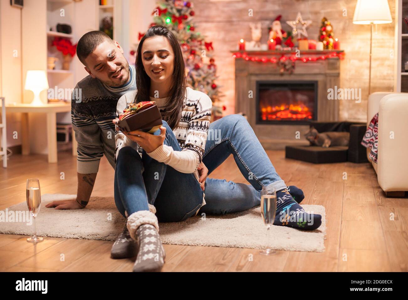 Happy girlfriend about her christmas gift from boyfriend in front of ...