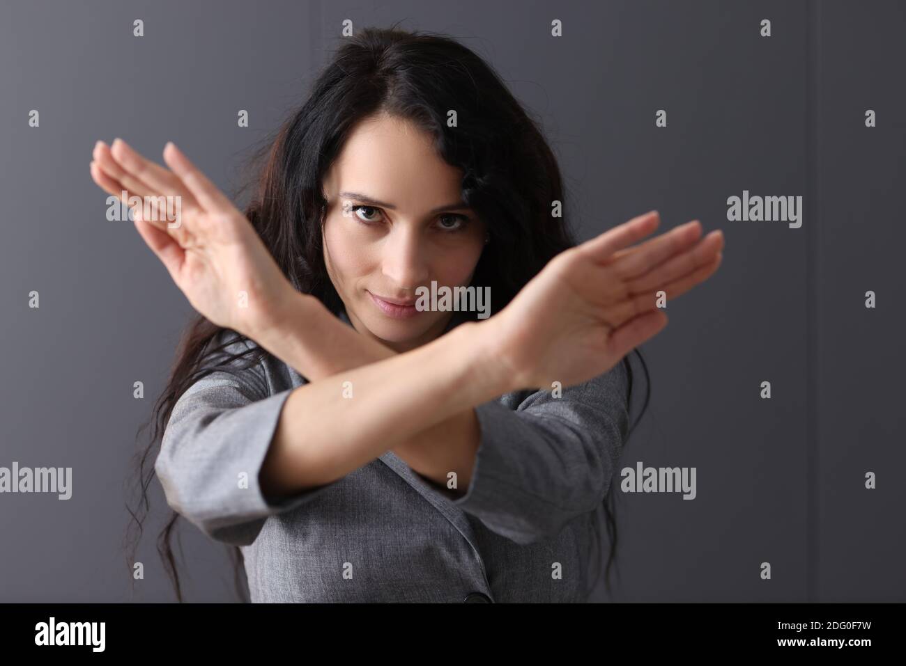Business woman folding her arms in front of her Stock Photo - Alamy