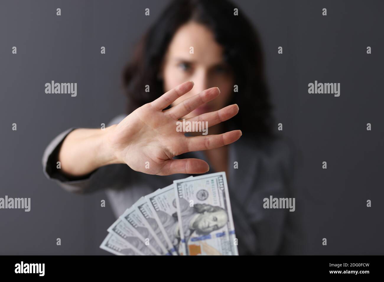 Business woman with hand refusing offered money closeup Stock Photo - Alamy
