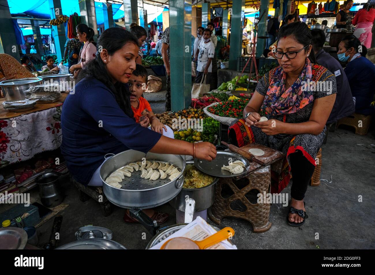Kalimpong, India - October 2020: Two women preparing momos at the Haat ...