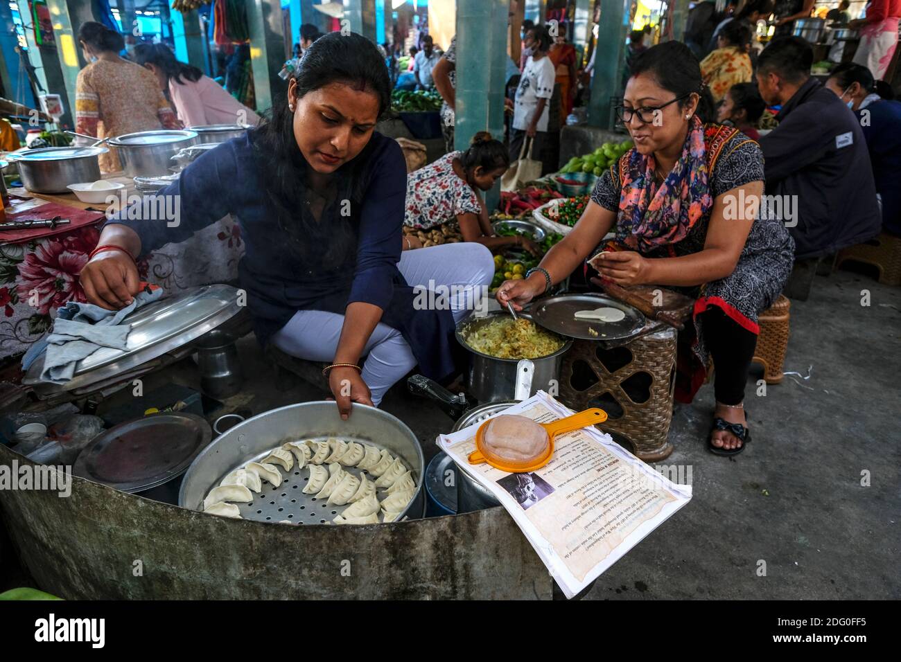 Kalimpong, India - October 2020: Two women preparing momos at the Haat ...