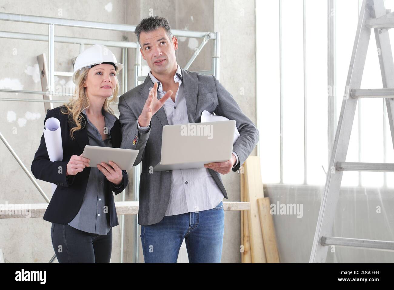 man and woman architects or engineers with computer work together in ...