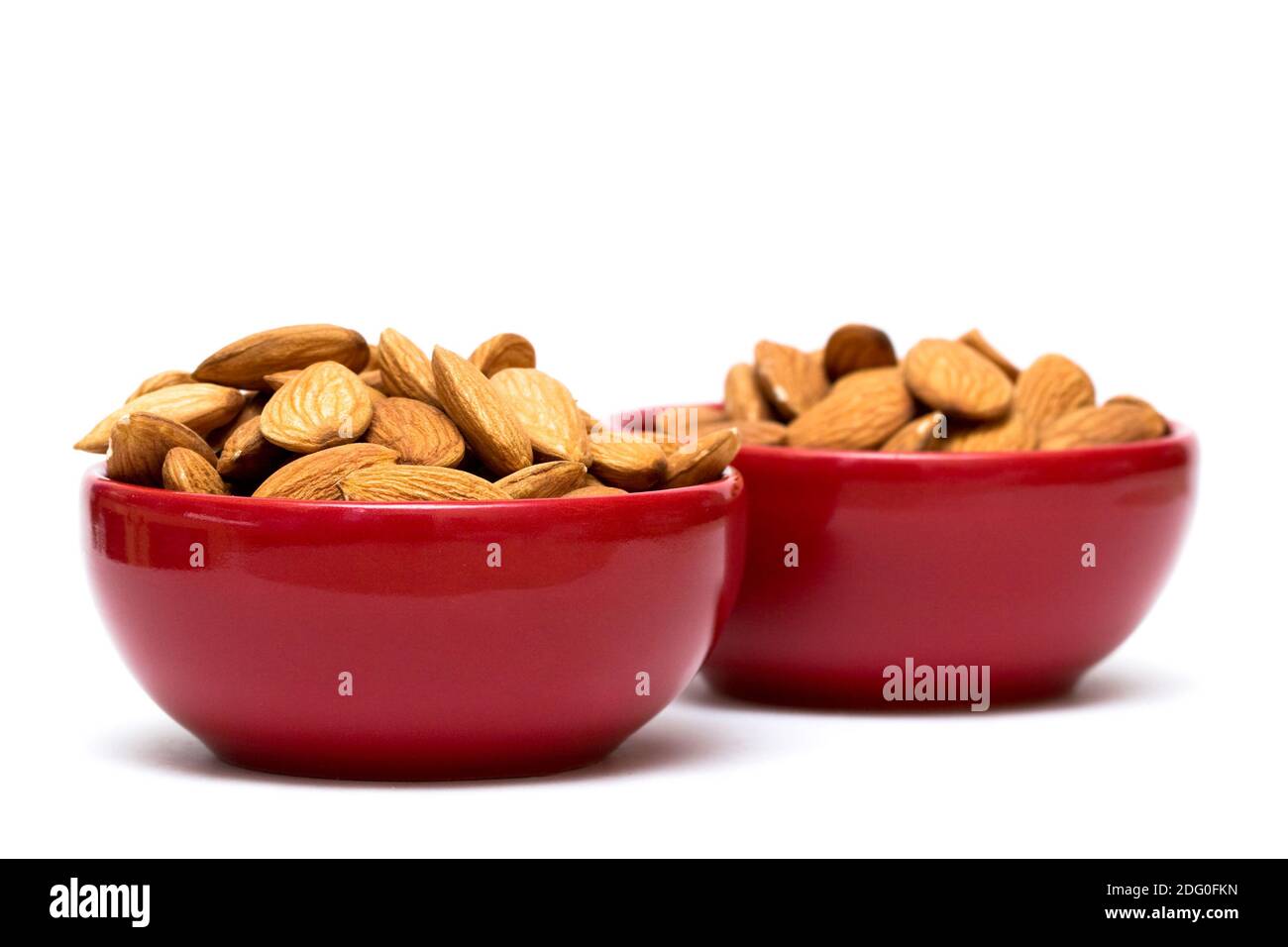 Almonds in a red dish Stock Photo - Alamy