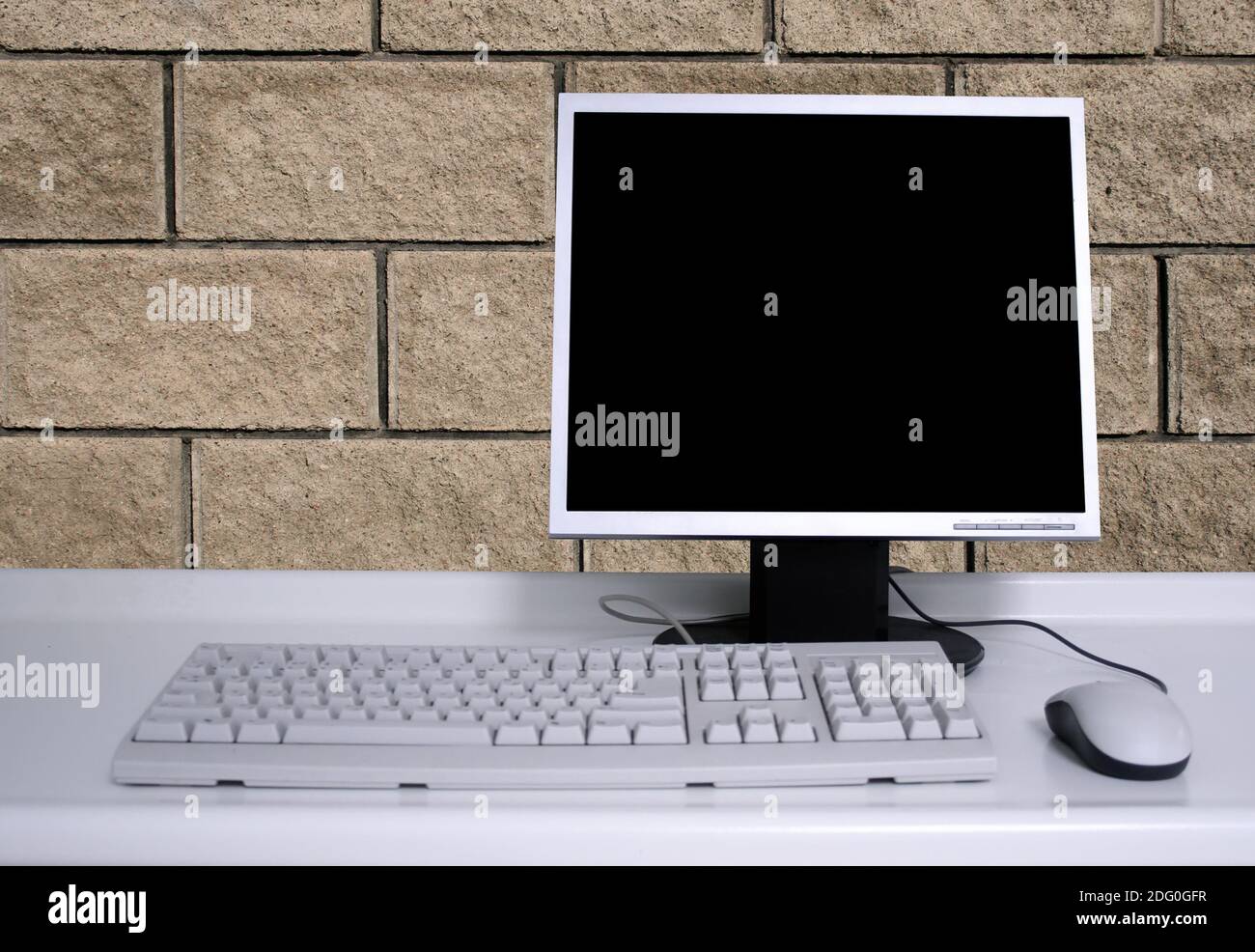 PC with black desktop and brick wall background Stock Photo - Alamy