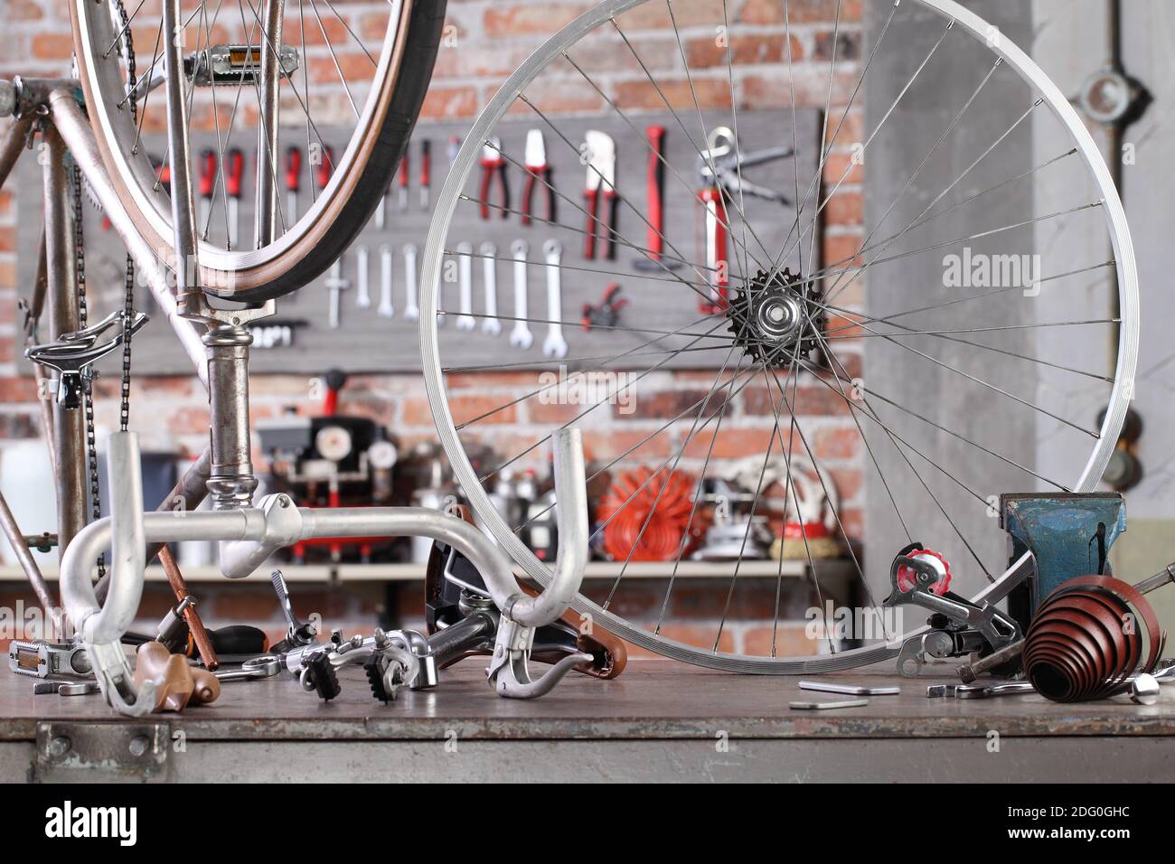 vintage bicycle in garage workshop on the workbench with tools, diy and ...
