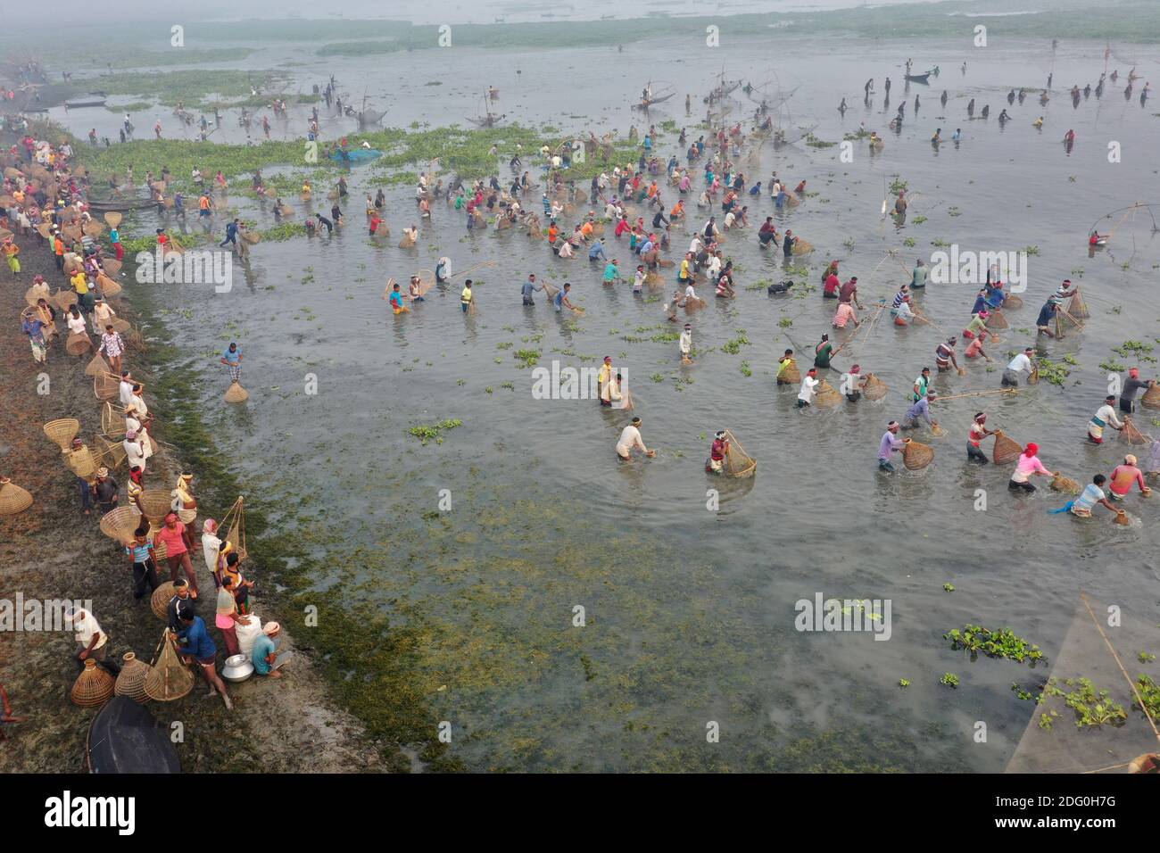 Pabna, Bangladesh - December 05, 2020: Thousands of fishermen gathered at Dikshir Beel in ...