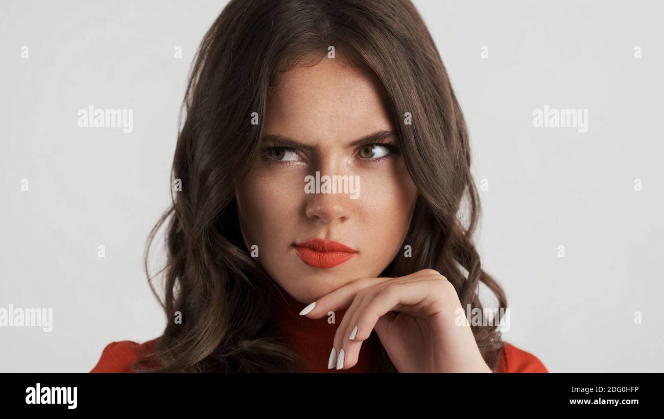 Close up attractive slyly girl thoughtfully looking away over white ...