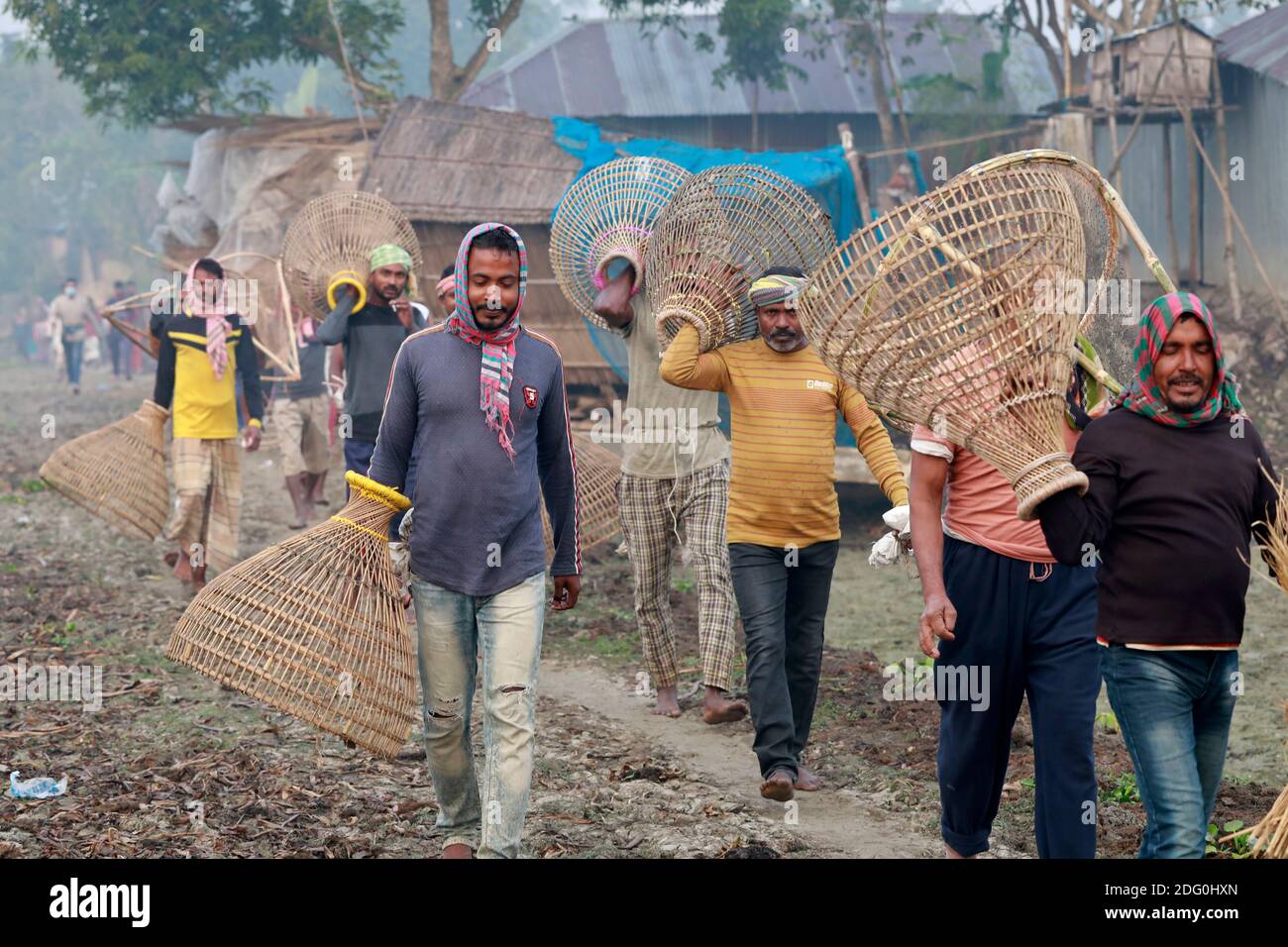 Pabna, Bangladesh - December 05, 2020: People line up in groups to visit Dikshir Beel in ...