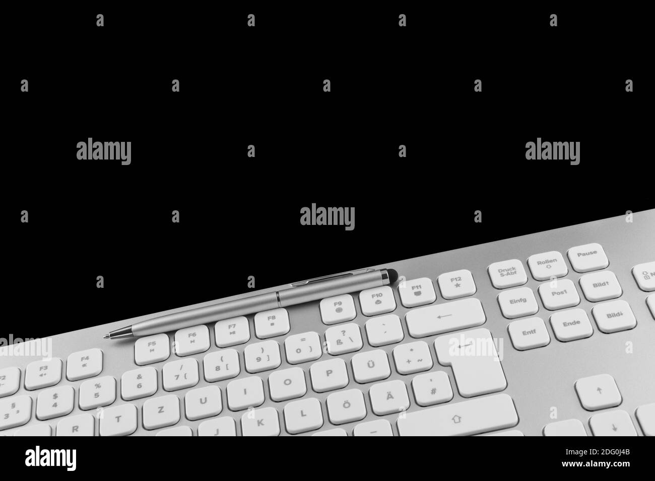 PC keyboard and pen against black background Stock Photo - Alamy