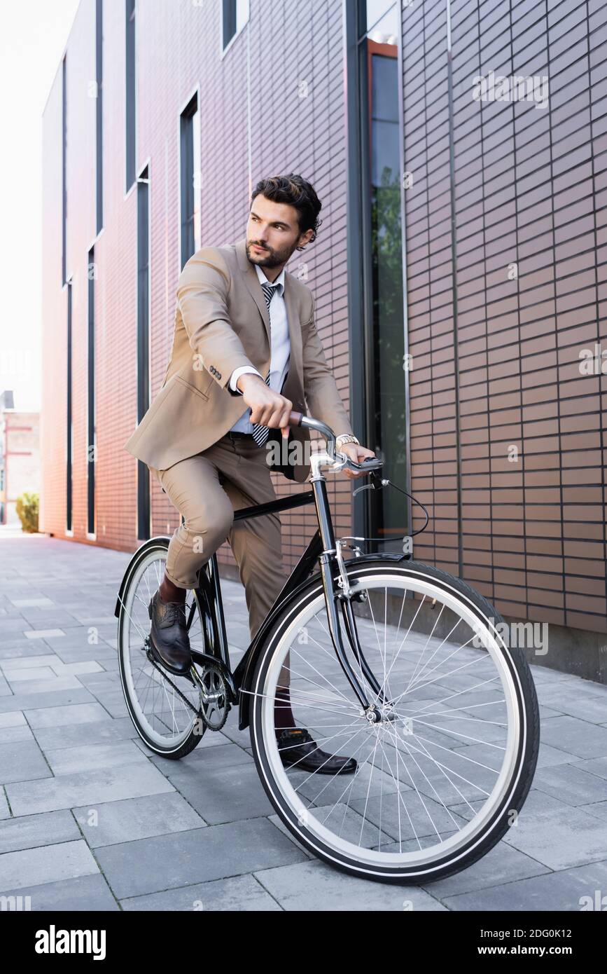 Man In Suit Riding Bicycle