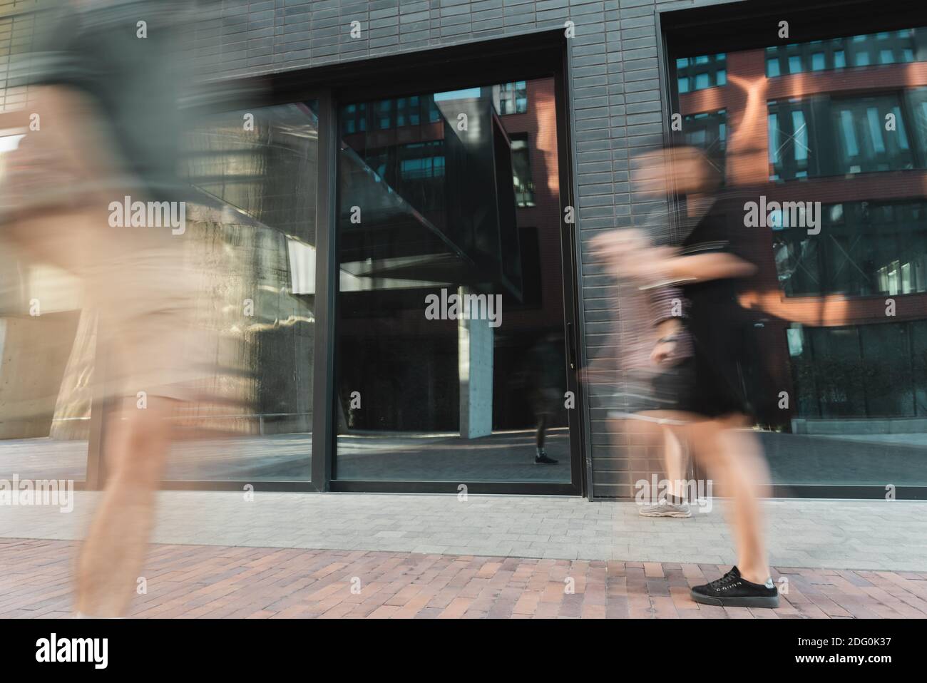 motion blur of people walking on modern street near building Stock ...