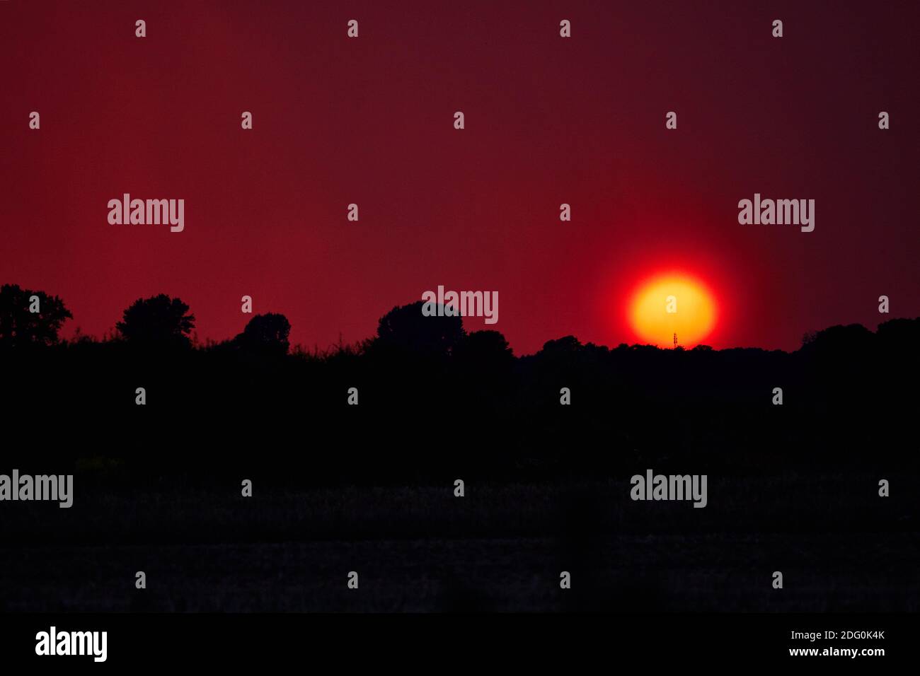 amazing apocalyptic sunset set against a red-purple sky Stock Photo - Alamy