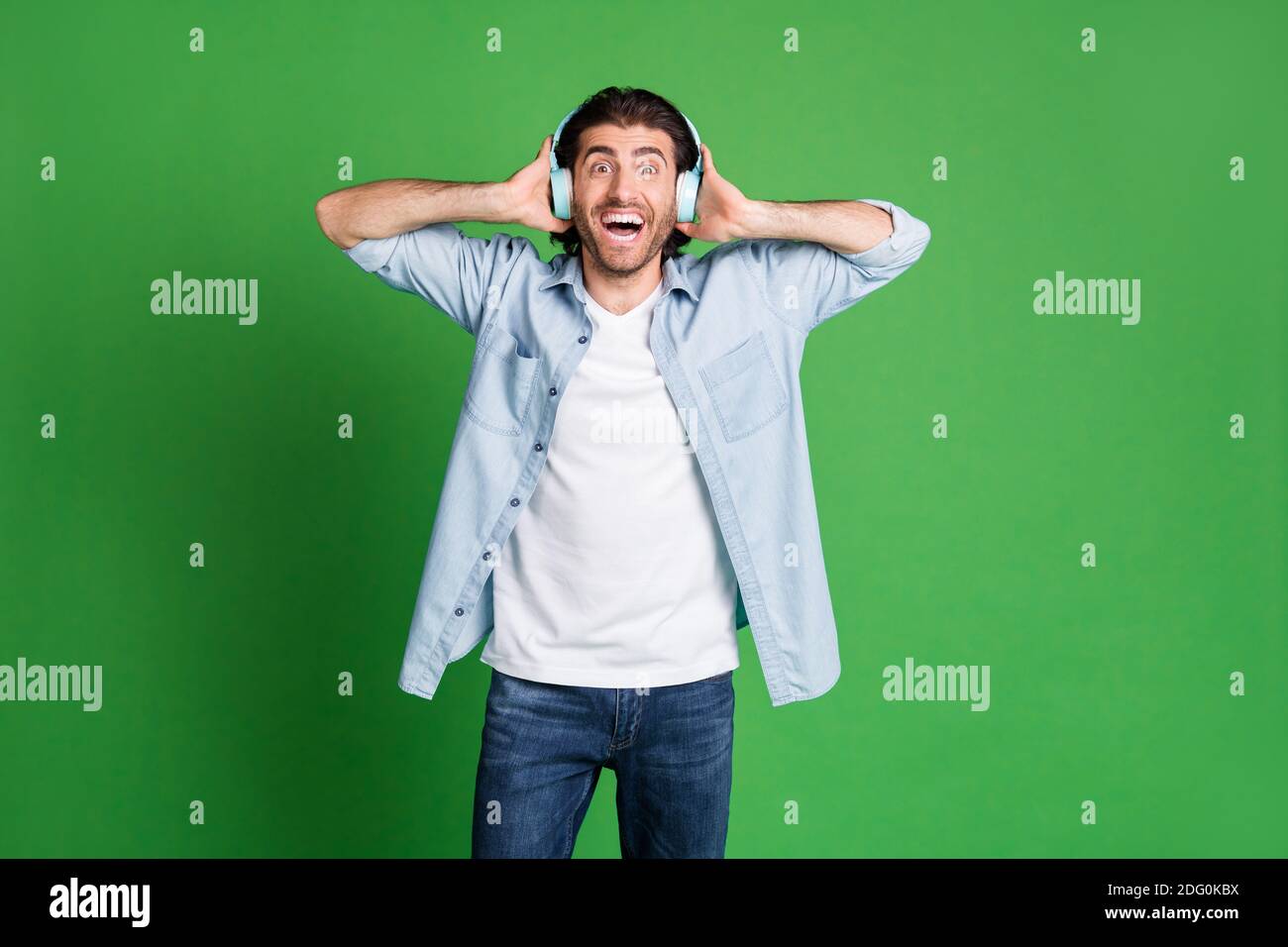 Photo of stubbled guy open mouth excited smiling wear headphones denim ...