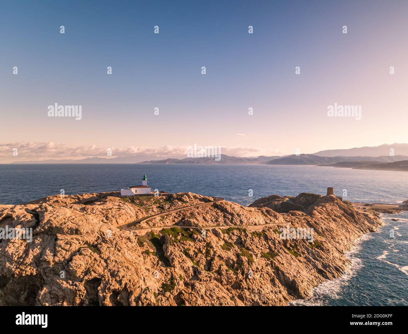 Aerial view of early morning sun on the lighthouse and Genoese tower at ...