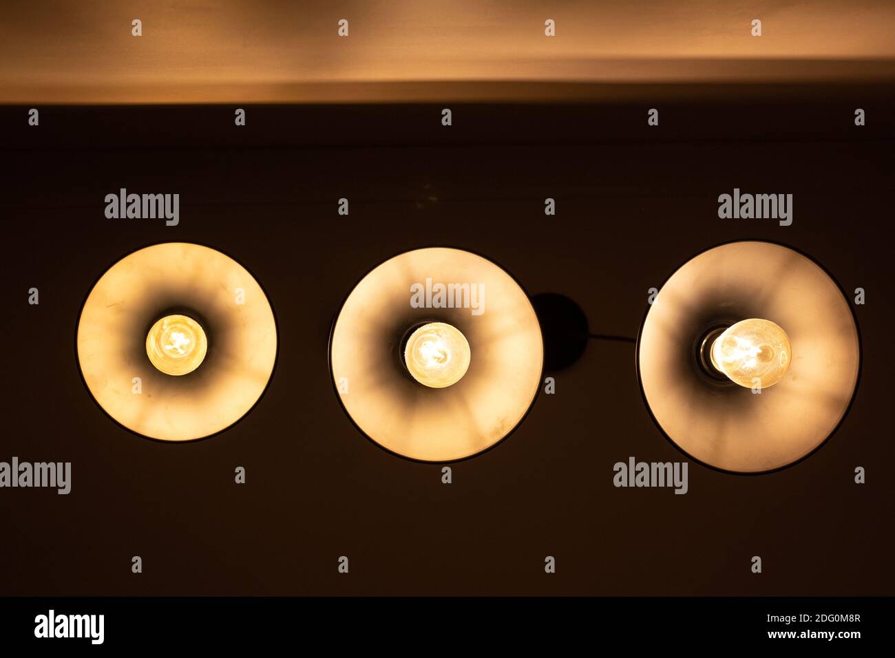 Three round lamps on the ceiling, bottom view Stock Photo - Alamy