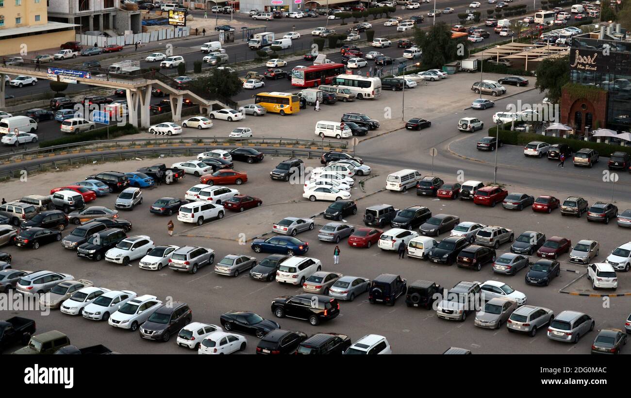 Kuwait City-Kuwait - 12/15/2019: Cars parked in open space next to busy ...