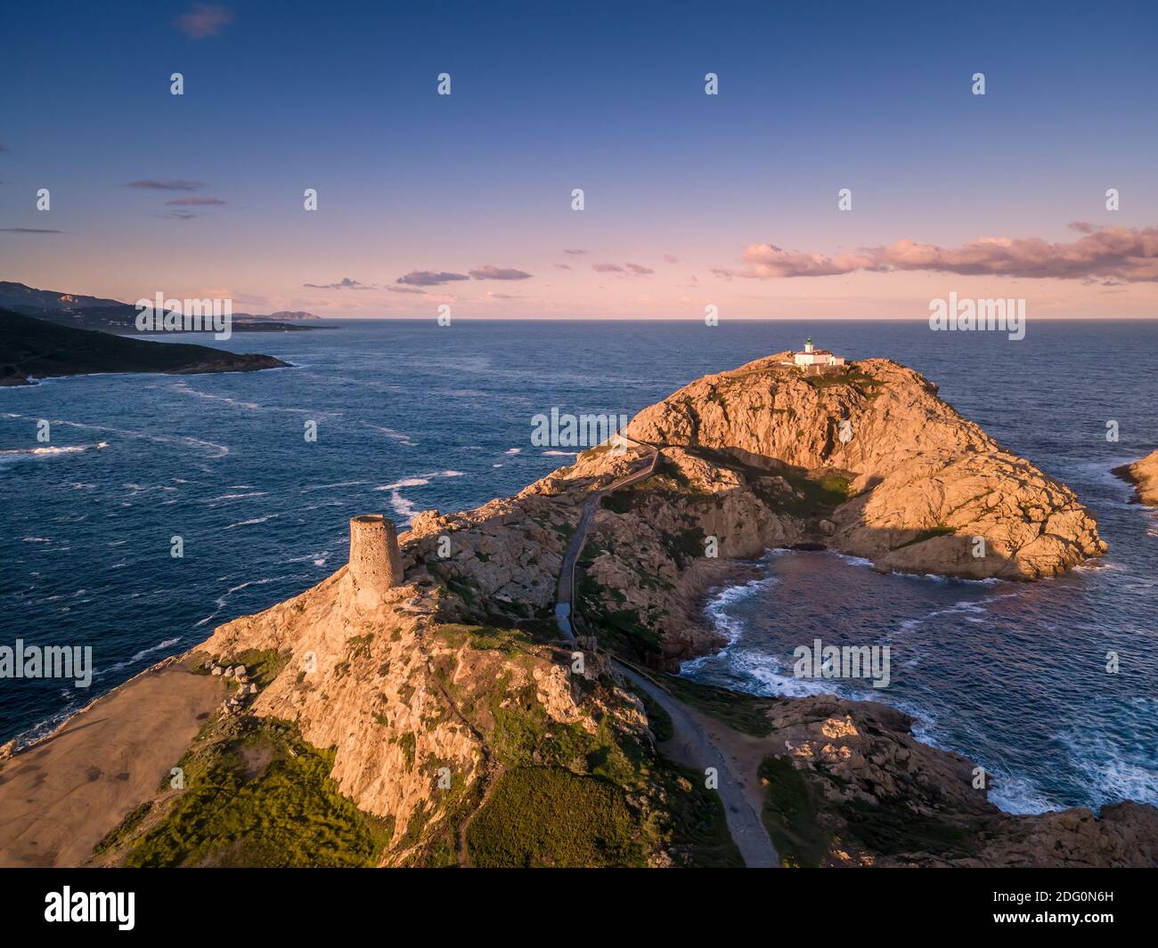Aerial view of early morning sun on the lighthouse and Genoese tower at ...