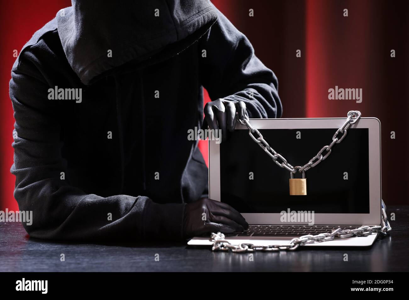 International hacker in black pullover and black mask trying to hack ...