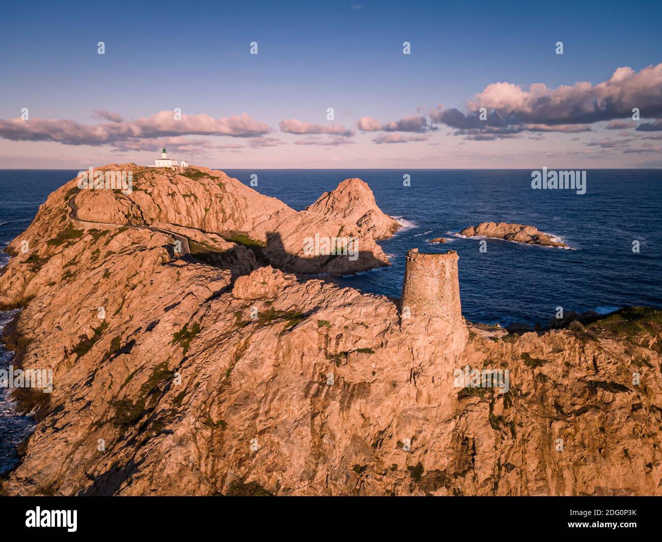 Aerial view of early morning sun on the lighthouse and Genoese tower at ...