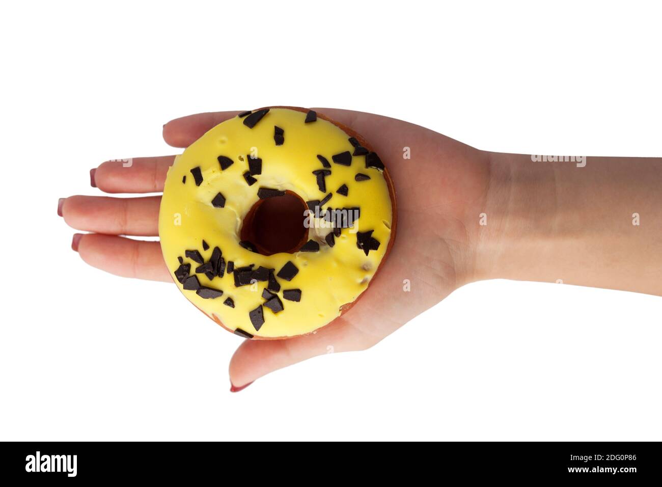 Female hand holds with fingers a donut in yellow glaze isolated on ...