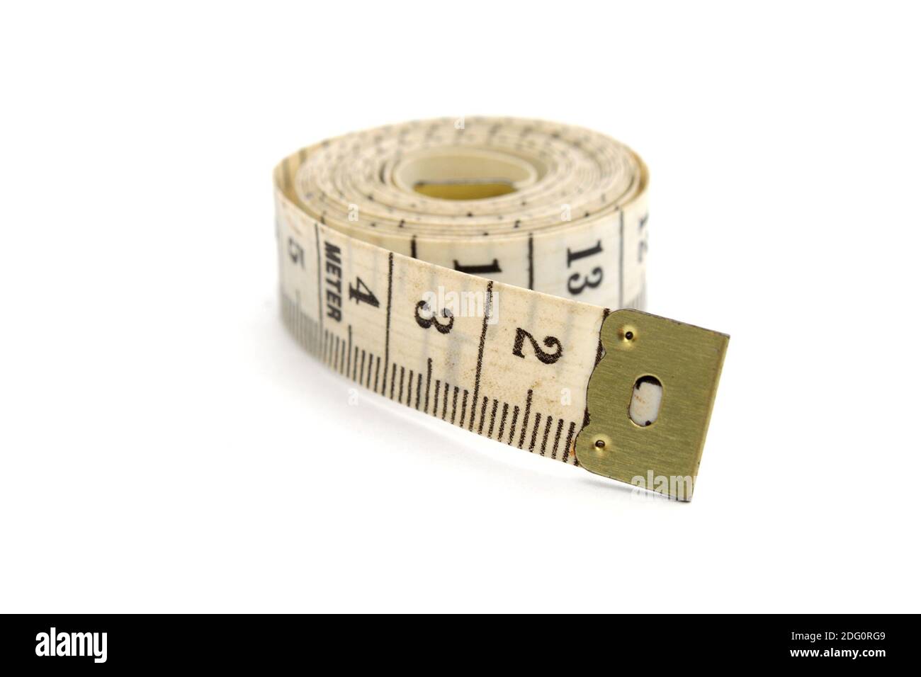 Rolled measuring tape isolated on white Stock Photo - Alamy