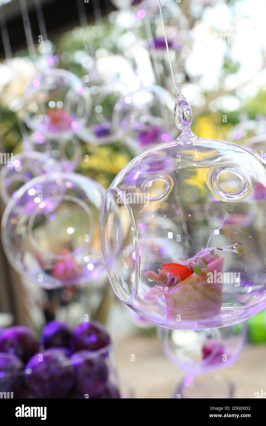 May 20, 2016: A vertical shot of canapes served in hanging glass domes ...
