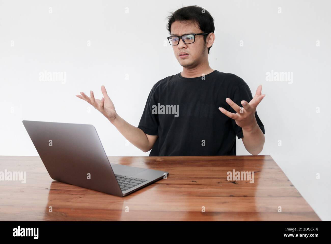 Young Asian man feeling stress and confuse with work in laptop ...