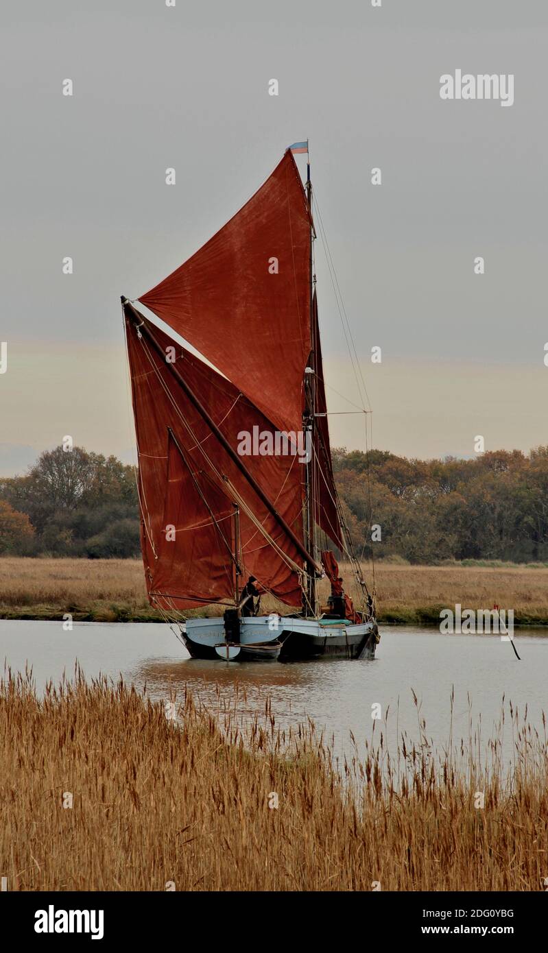 A traditional sailing barge navigating along the River Alde from Snape ...