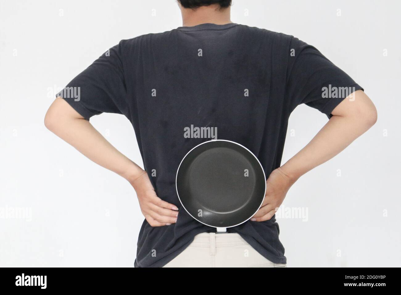 Young Asian man is angry and ready to strike with a frying pan ...