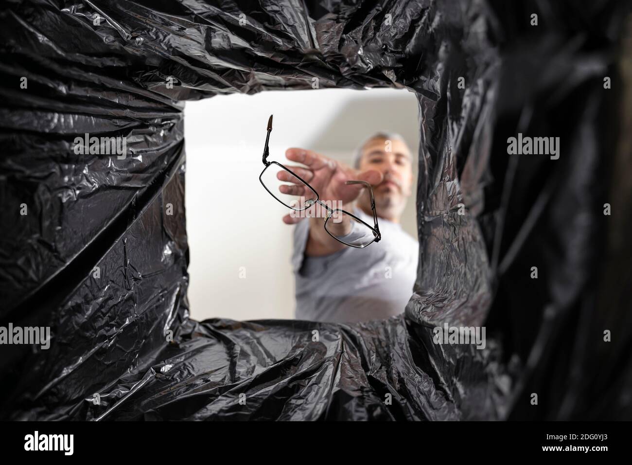a man throws his glasses into the trash. view from garbage. rejection ...