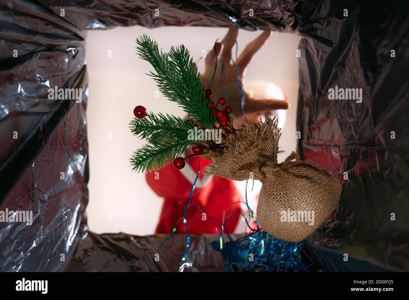 Santa throws Christmas decorations in the trash. view from the dumpster ...