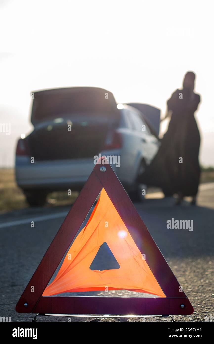 Car breakdown on the road, warning sign on the asphalt Stock Photo - Alamy