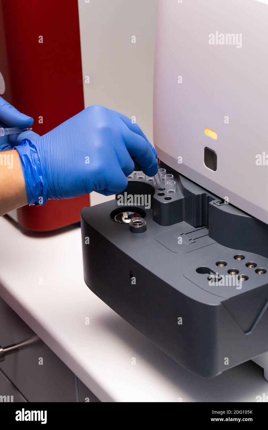 Introduction of blood samples in a biochemistry machine Stock Photo - Alamy