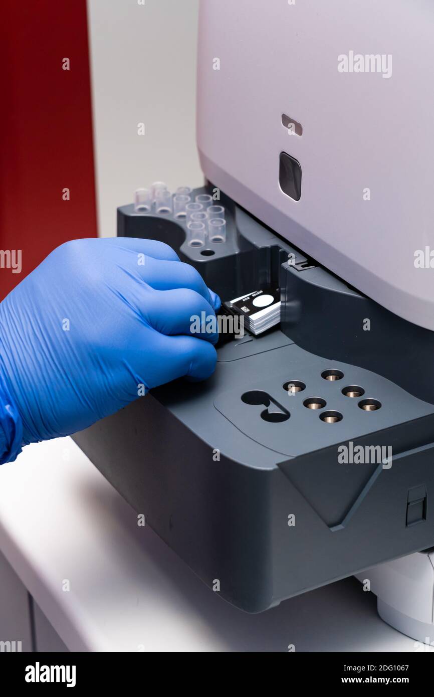 Introduction of blood samples in a biochemistry machine Stock Photo - Alamy
