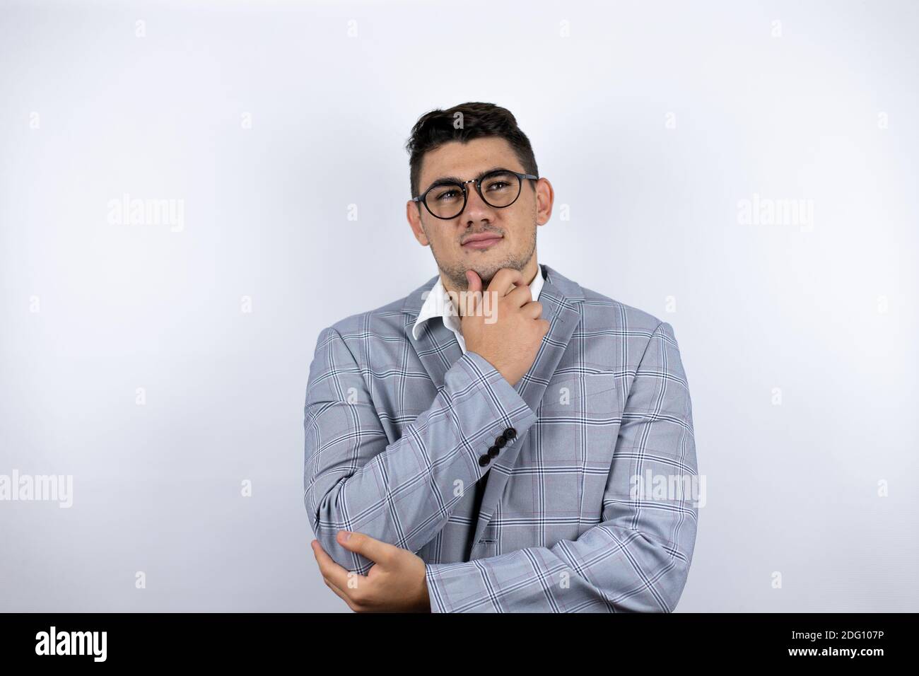 Business young man wearing a casual shirt over white background looking ...