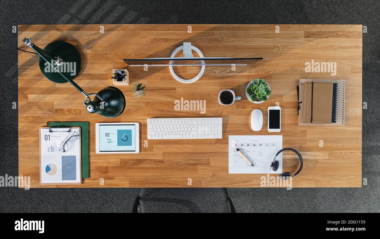 Top view of desk with computer, tablet and paperwork in home office ...