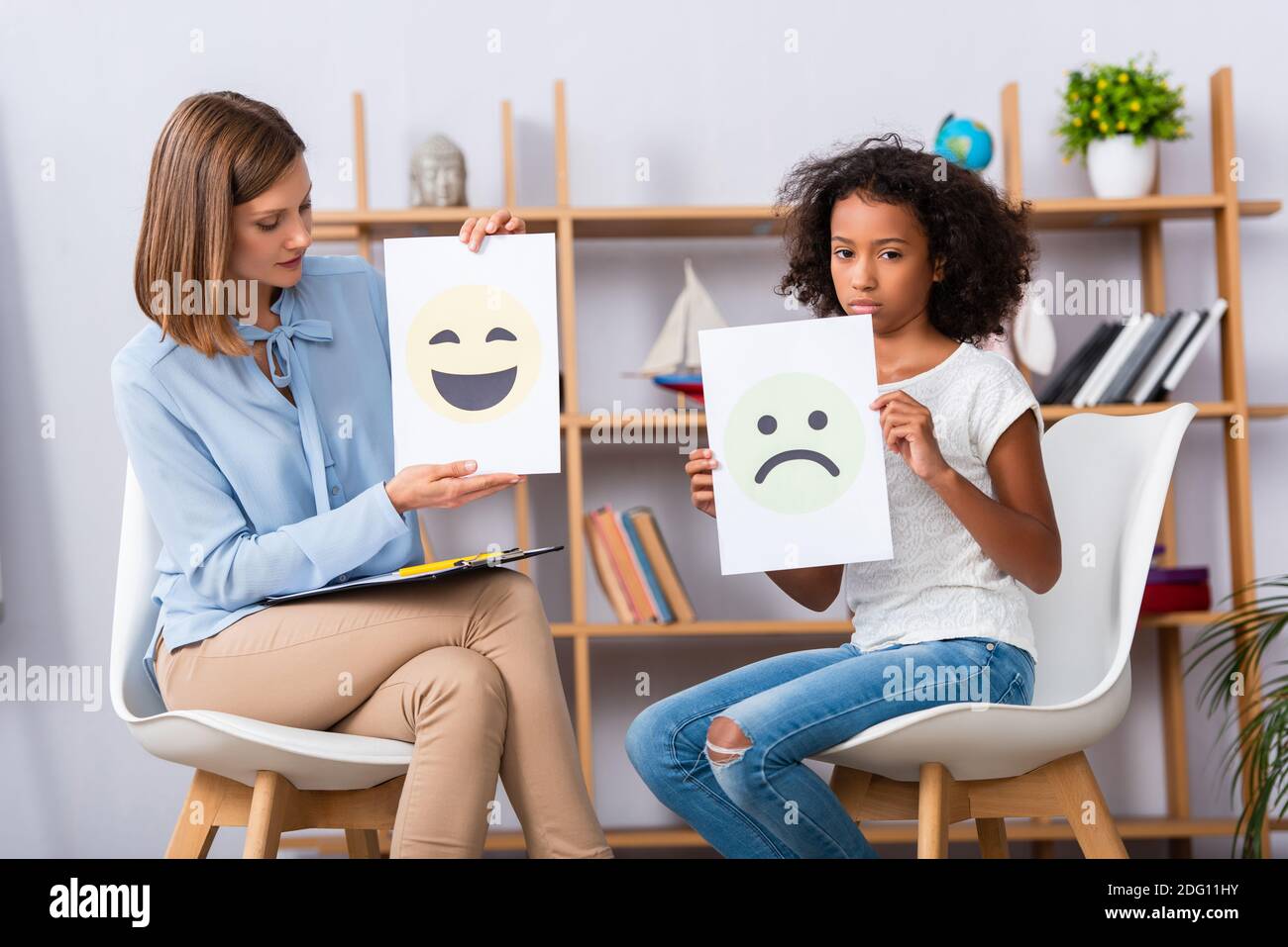 Psychologist and african american girl with autism showing sad and ...