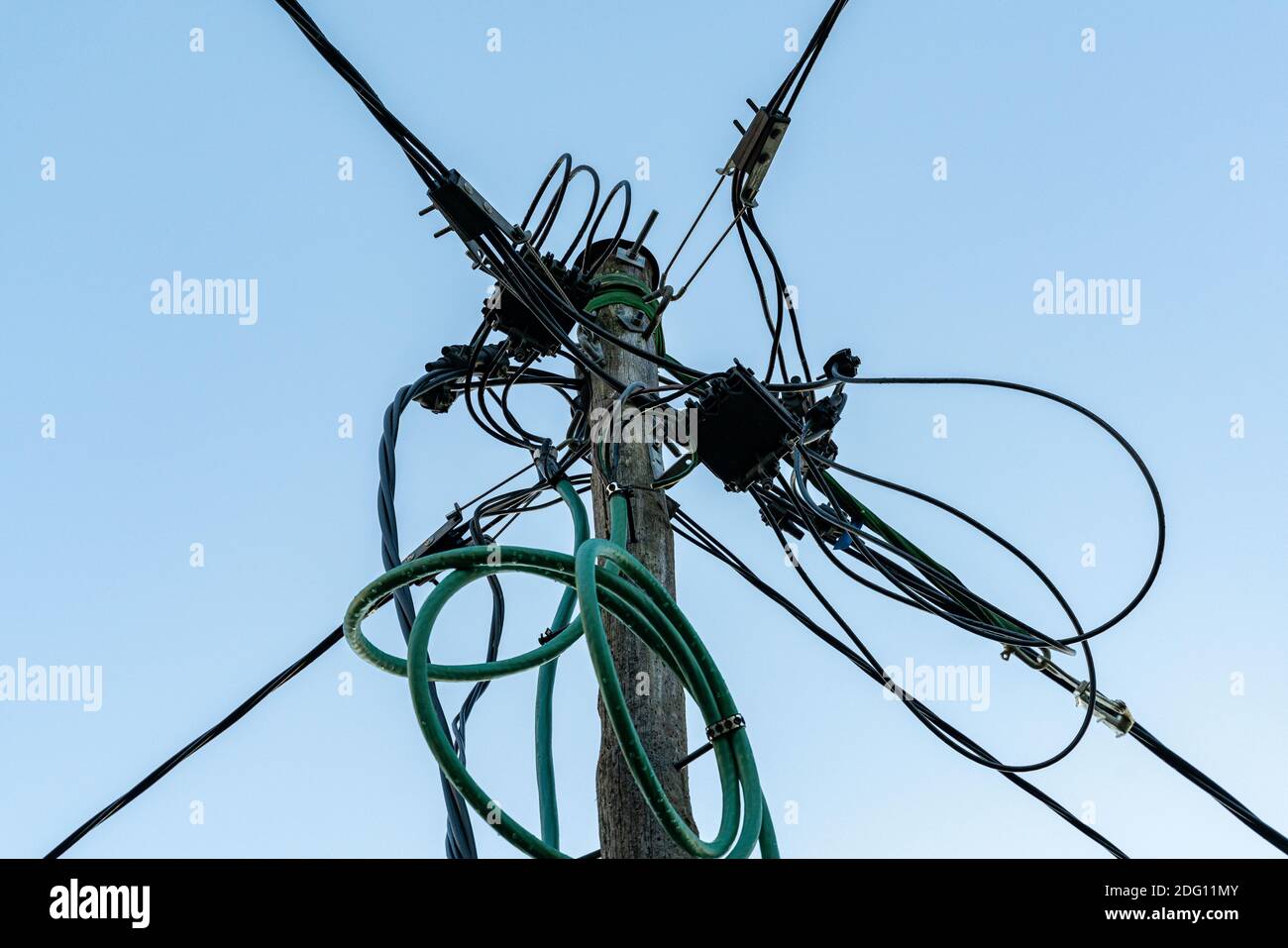 Chaotic mess of power lines and phone cables in a wooden mast Stock ...