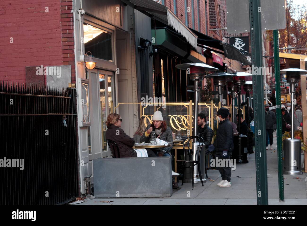 outdoor diners sitting at a table on the sidewalk at a restaurant in ...
