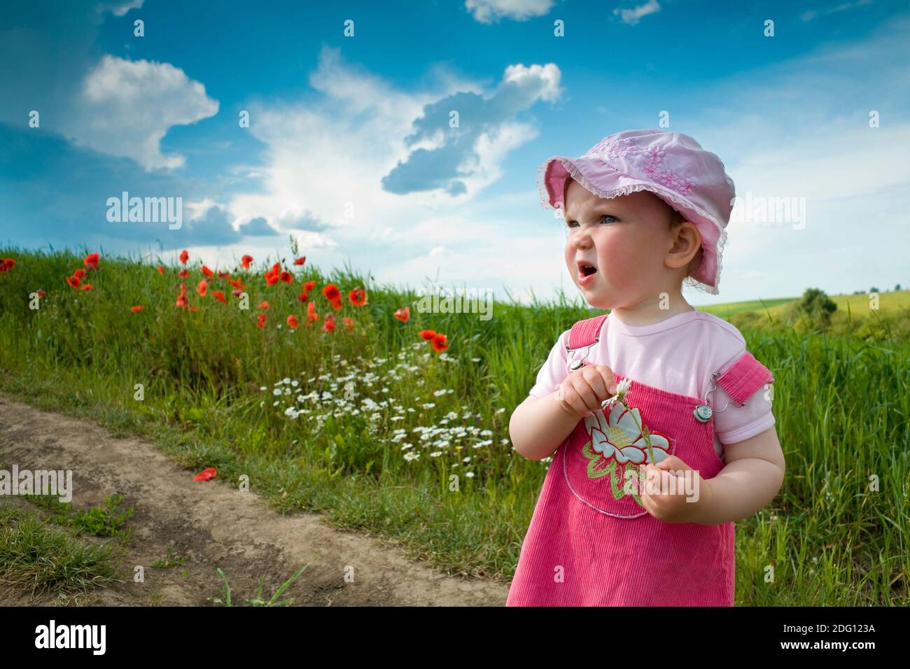 Girl walking on poppy field hi-res stock photography and images - Alamy
