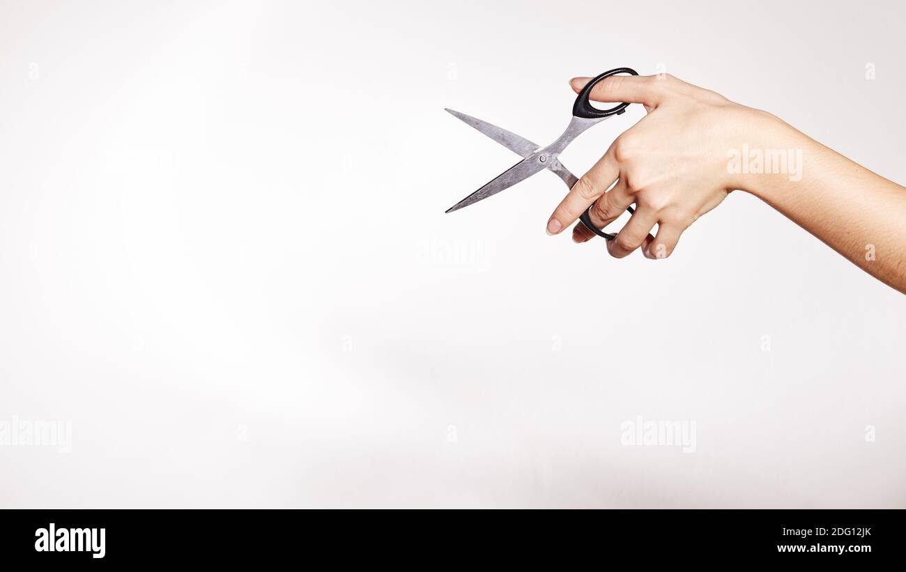 Female Hand is Holding Scissors. Copy Space for your Text. Isolated on ...
