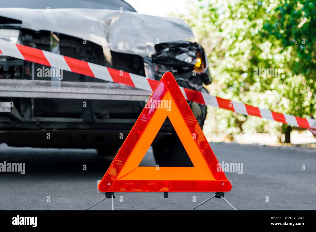 Police tape and Red emergency stop triangle sign on road in front of ...