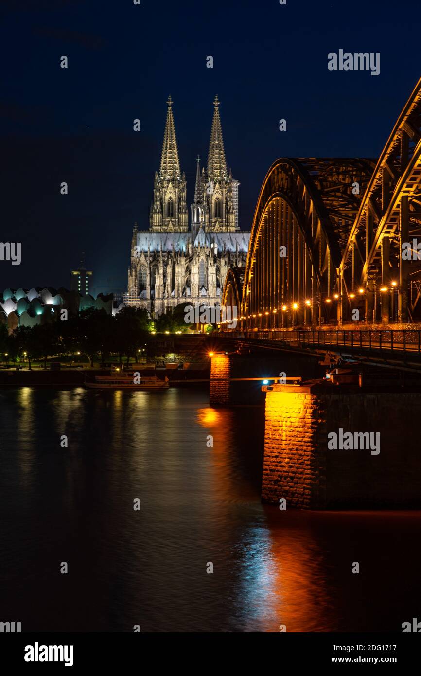 An illuminated Hohenzollern Arch Bridge and a historic ancient ...