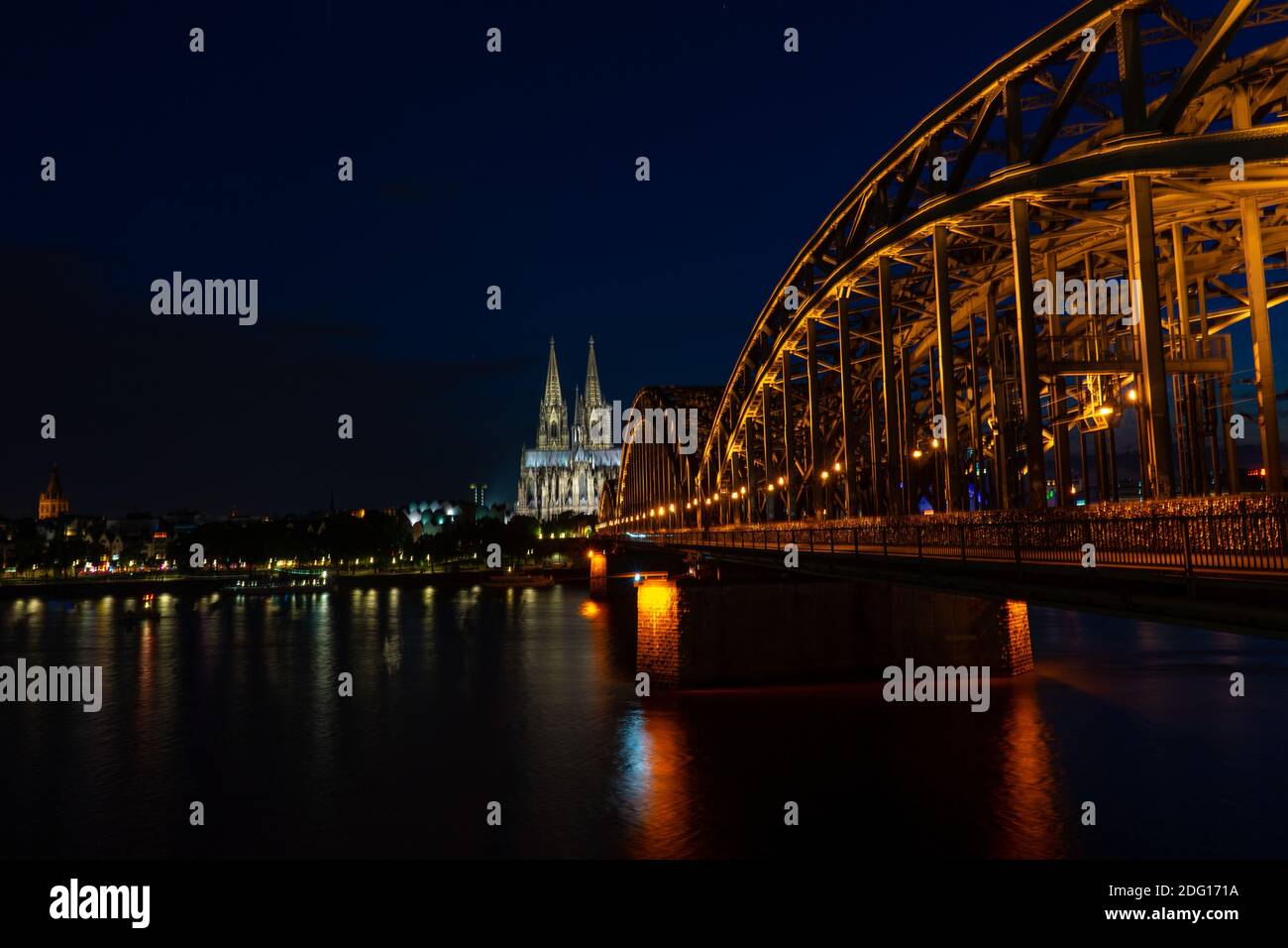 An illuminated Hohenzollern Arch Bridge and a historic ancient ...
