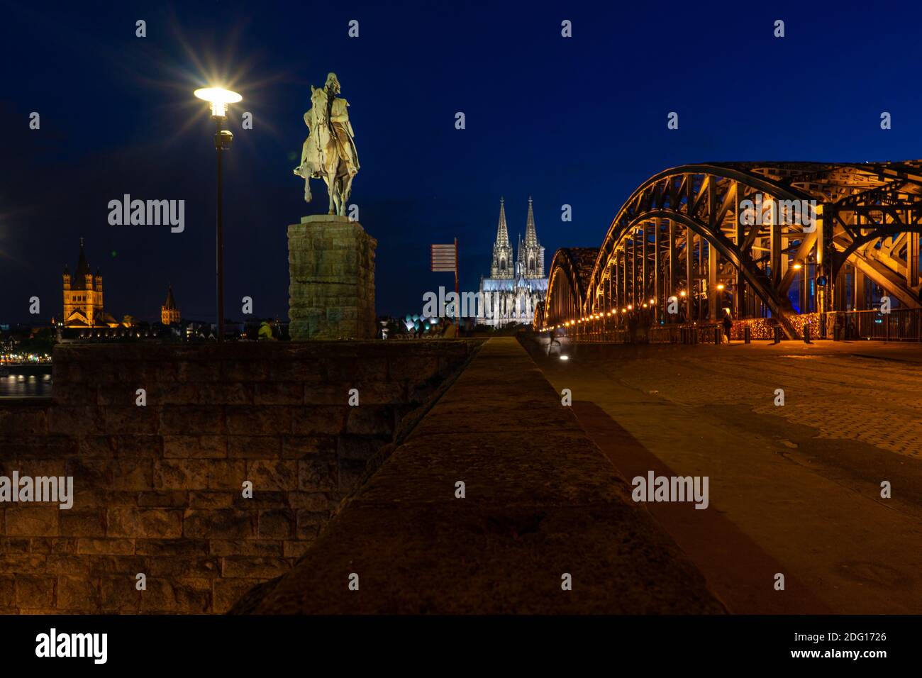 An illuminated Hohenzollern Arch Bridge and a historic ancient ...